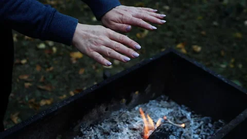 Warm your hands by the fire in the cold ... | Stock Video | Pond5