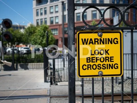 Photograph: Warning look before crossing yellow warning sign at train ...