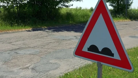 Warning traffic sign about bumps in road... | Stock Video | Pond5