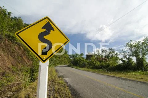 Warning winding traffic sign winding road on background Stock Photo ...