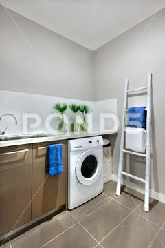 A washing area with a washing machine of a modern house Stock Photo ...