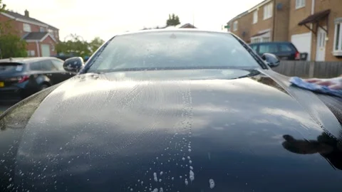 Washing black car hood bonnet right | Stock Video | Pond5