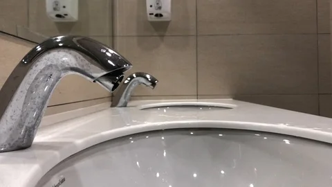 Washing hands with automatic sensor wate... | Stock Video | Pond5