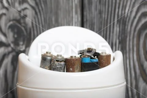 Waste bin. It contains finger-type batteries coated with corrosion ...