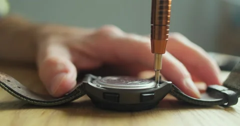 Watchmaker unscrews a screw on a watch t... | Stock Video | Pond5