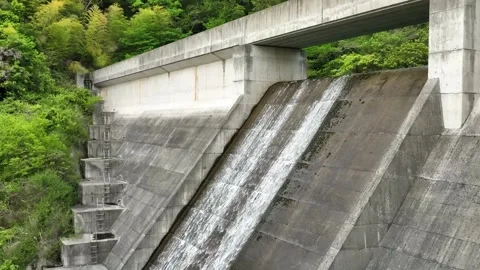 Water cascades down concrete dam spillwa... | Stock Video | Pond5