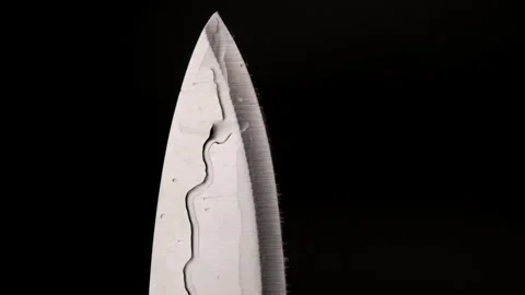 Water drop on sharp knife isolated on da... | Stock Video | Pond5