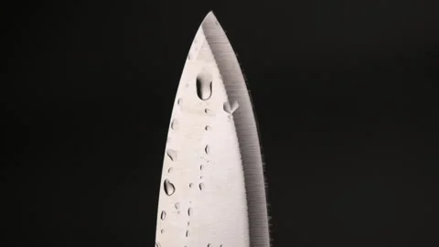 Water drop on sharp knife isolated on da... | Stock Video | Pond5