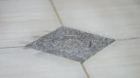 Water drops drip into clogged grey drain... | Stock Video | Pond5