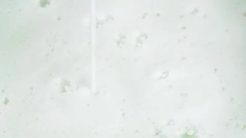 Water drops falling in white foam, top v... | Stock Video | Pond5