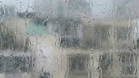 Water drops of rain on wet window glass ... | Stock Video | Pond5