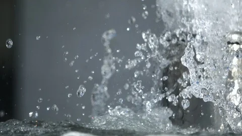 Water drops splashing on water surface. ... | Stock Video | Pond5