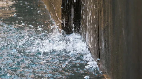 Water falling down from a stone wall in ... | Stock Video | Pond5