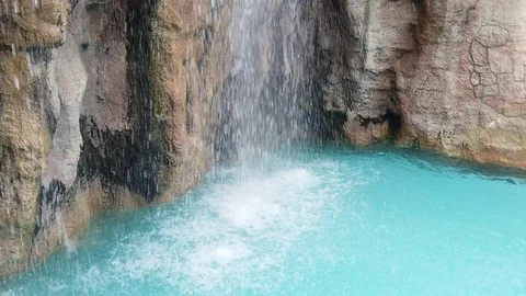 water falling pouring into a poolside fr... | Stock Video | Pond5