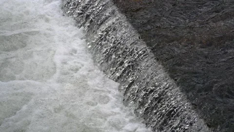 Water flow drainage going into the river... | Stock Video | Pond5