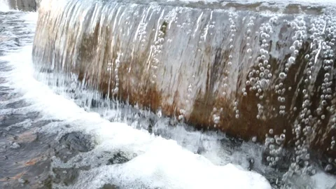 water flow falling down into water makin... | Stock Video | Pond5