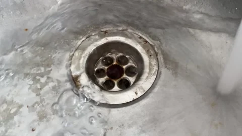 Water flowing into dirty mesh drain kitc... | Stock Video | Pond5