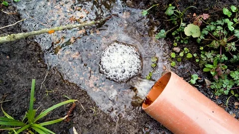 Water flowing out of a plastic pipe form... | Stock Video | Pond5