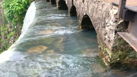 Water flows through stone drains and fal... | Stock Video | Pond5