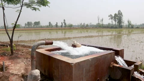 Water gushing out from tube well through... | Stock Video | Pond5