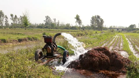 Water gushing out from tube well through... | Stock Video | Pond5