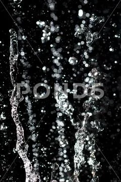 Water jet with spray on a black background Stock Photo #196060785