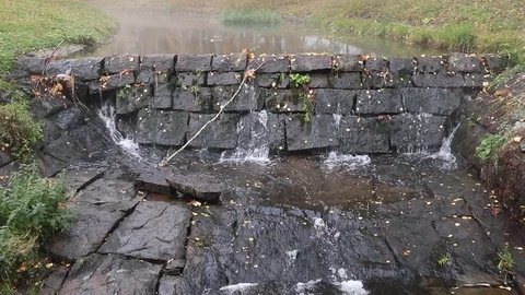 water leaking through stone dam construc... | Stock Video | Pond5