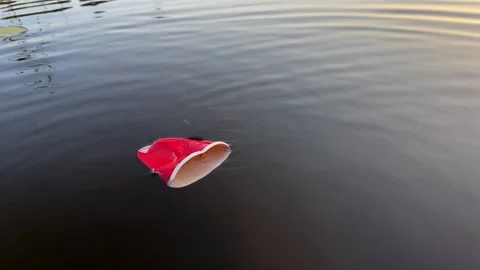 Water pollution. Coffee paper cup Garbag... | Stock Video | Pond5