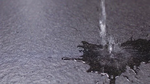 water poured on a slab of black granite, | Stock Video | Pond5