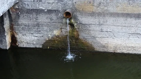 Water pouring from canal pipe | Stock Video | Pond5