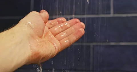 Water pouring from shower on hand | Stock Video | Pond5