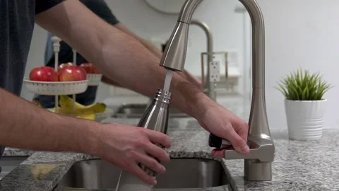 Water pouring from tap to fill up reusab... | Stock Video | Pond5