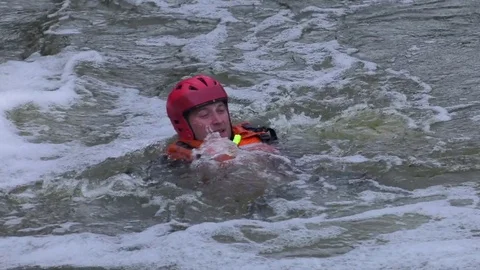 water rescue man floating down stream 4k | Stock Video | Pond5