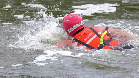water rescue man swimming up stream 4k | Stock Video | Pond5