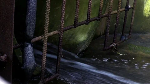 Water rushing out of storm drain gate fr... | Stock Video | Pond5