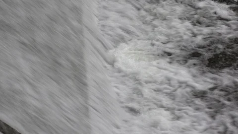 Water rushing over dam in autumn | Stock Video | Pond5