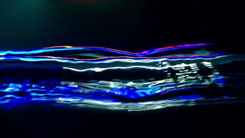 Water splash in slow motion on colorful ... | Stock Video | Pond5