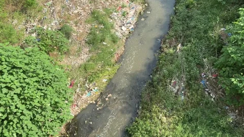 Water stream with plastic pollution. Dir... | Stock Video | Pond5
