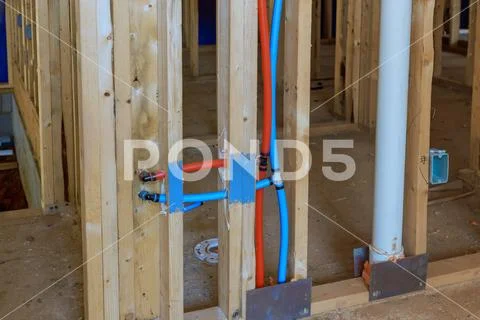 Water system integration in new home construction with red and blue pvc ...
