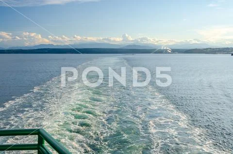 Photograph: Water trail view from ferry with blue sky and white clouds ...