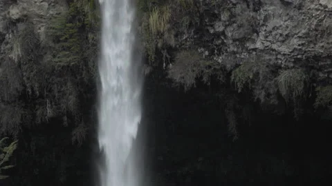 waterfall falling into dark cave entranc... | Stock Video | Pond5