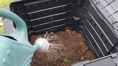 Watering compost for garden fertilizatio... | Stock Video | Pond5