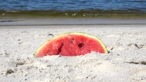 Watermelon thrown on the beach sand with... | Stock Video | Pond5