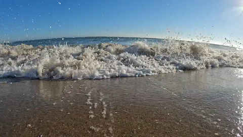 Waves building up and rolling onto the b... | Stock Video | Pond5