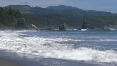 Waves crash against sea stack formations... | Stock Video | Pond5