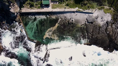 Waves crash into side of famous Hermanus... | Stock Video | Pond5