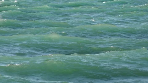 Waves sloshing and glowing brightly with... | Stock Video | Pond5