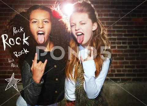 Photograph: We love Rock n Roll. two girls pulling faces and making a ...