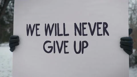 WE WILL NEVER GIVE UP sign on poster, cl... | Stock Video | Pond5