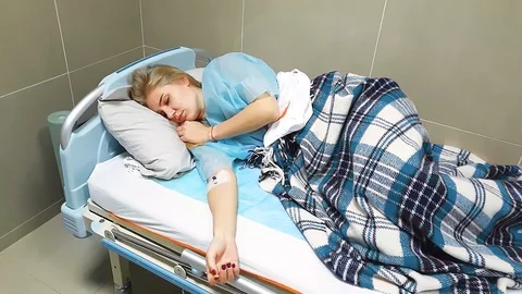 Weak, emaciated young woman is lying in ... | Stock Video | Pond5